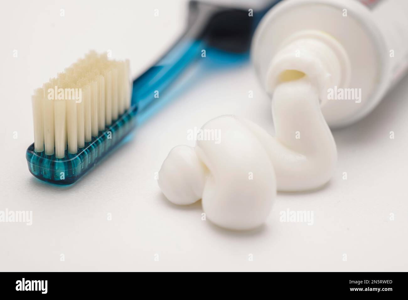 Toothpaste and toothbrush over a white background Stock Photo - Alamy