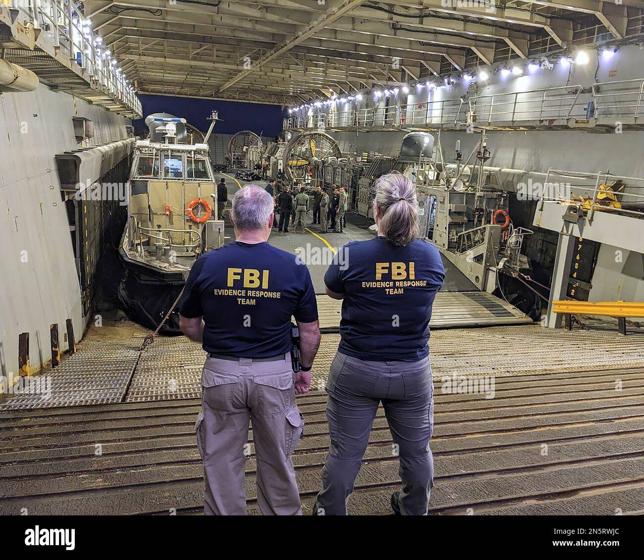 In this image provided by the FBI, FBI evidence response team members ...