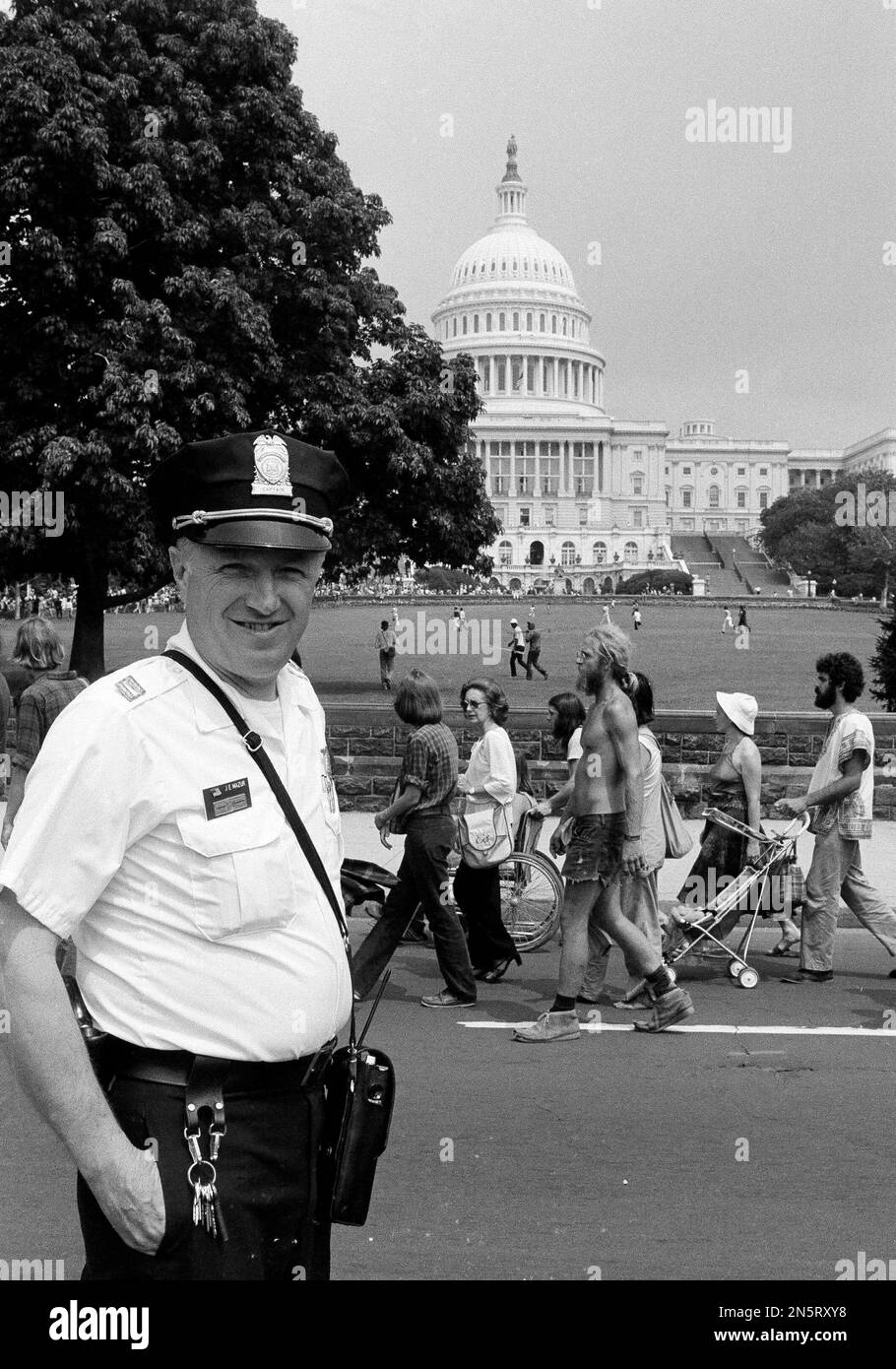 Police Capt. Joseph Mazur stands near the Capitol as marchers parade in ...