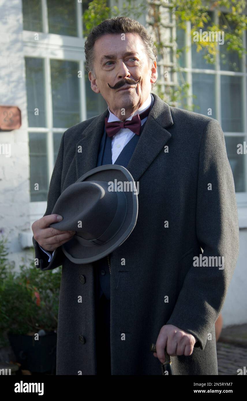 British actor Robert Powell, centre, dressed as the character Poirot ...