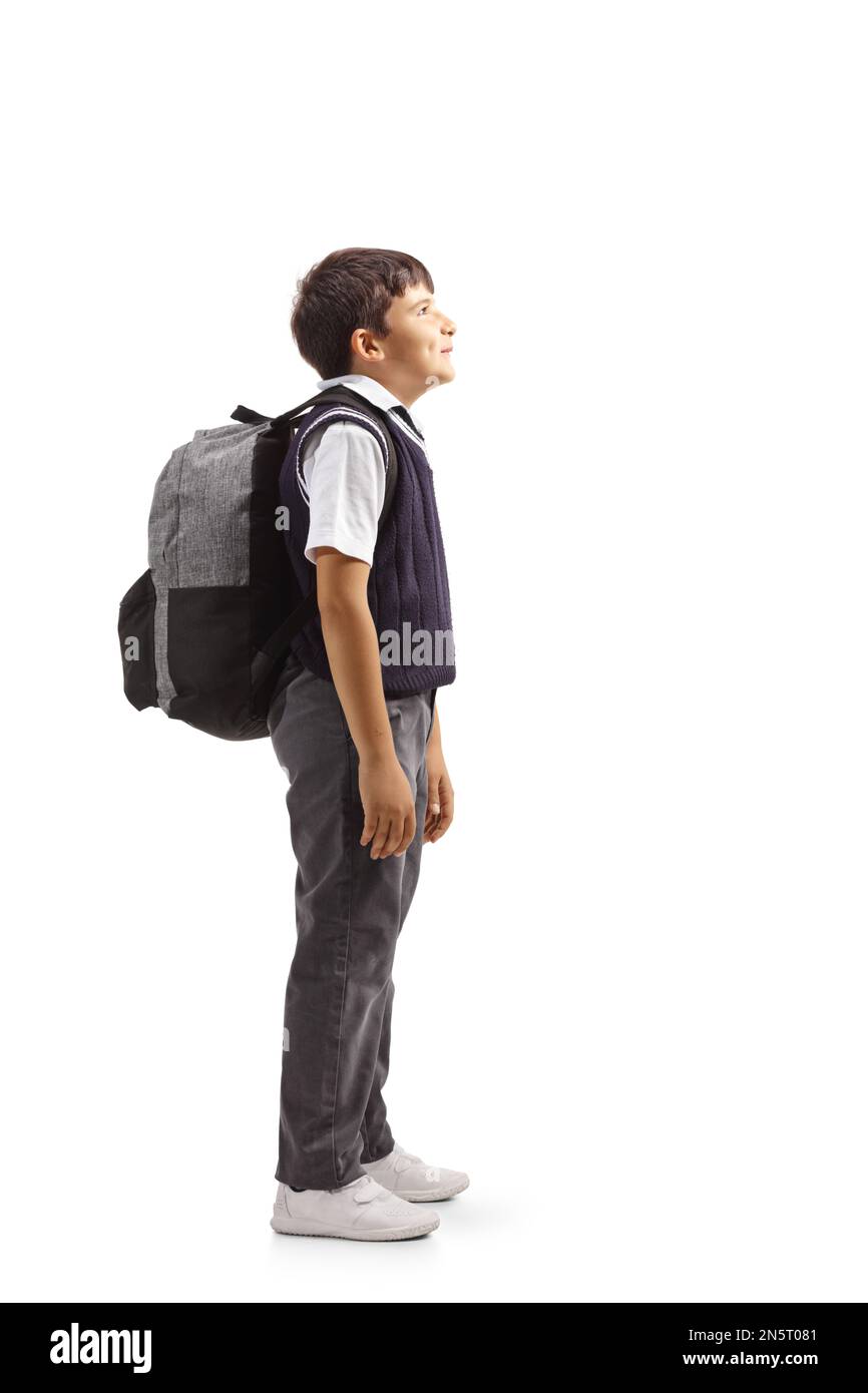 Full length profile shot of a boy in a school uniform carrying a ...