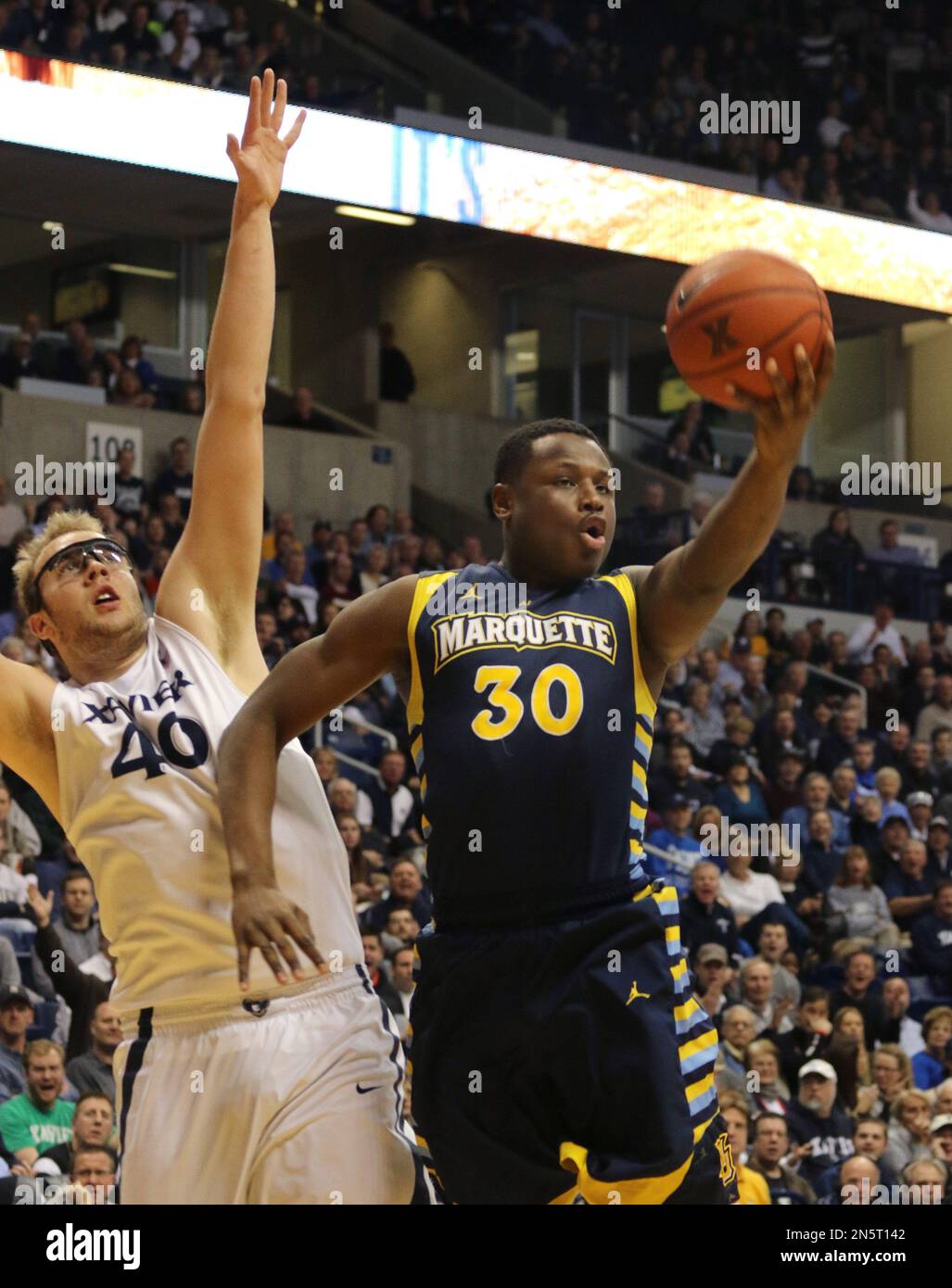 Xavier's Matt Stainbrook tries to keep Marquette's Deonte Burton from ...