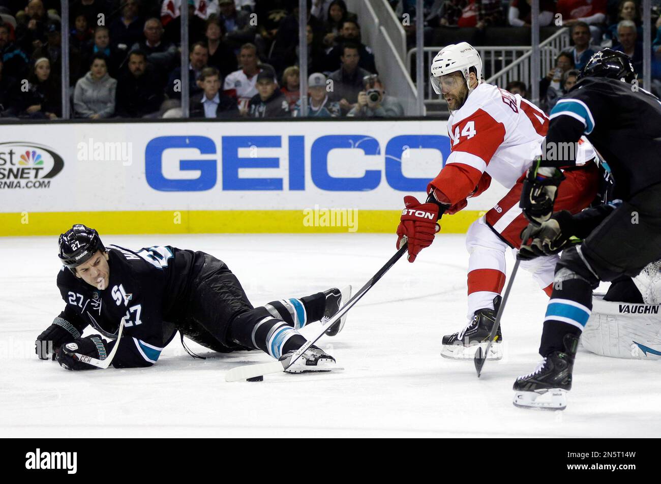 San Jose Sharks' Scott Hannan (27) falls down next to the puck as ...