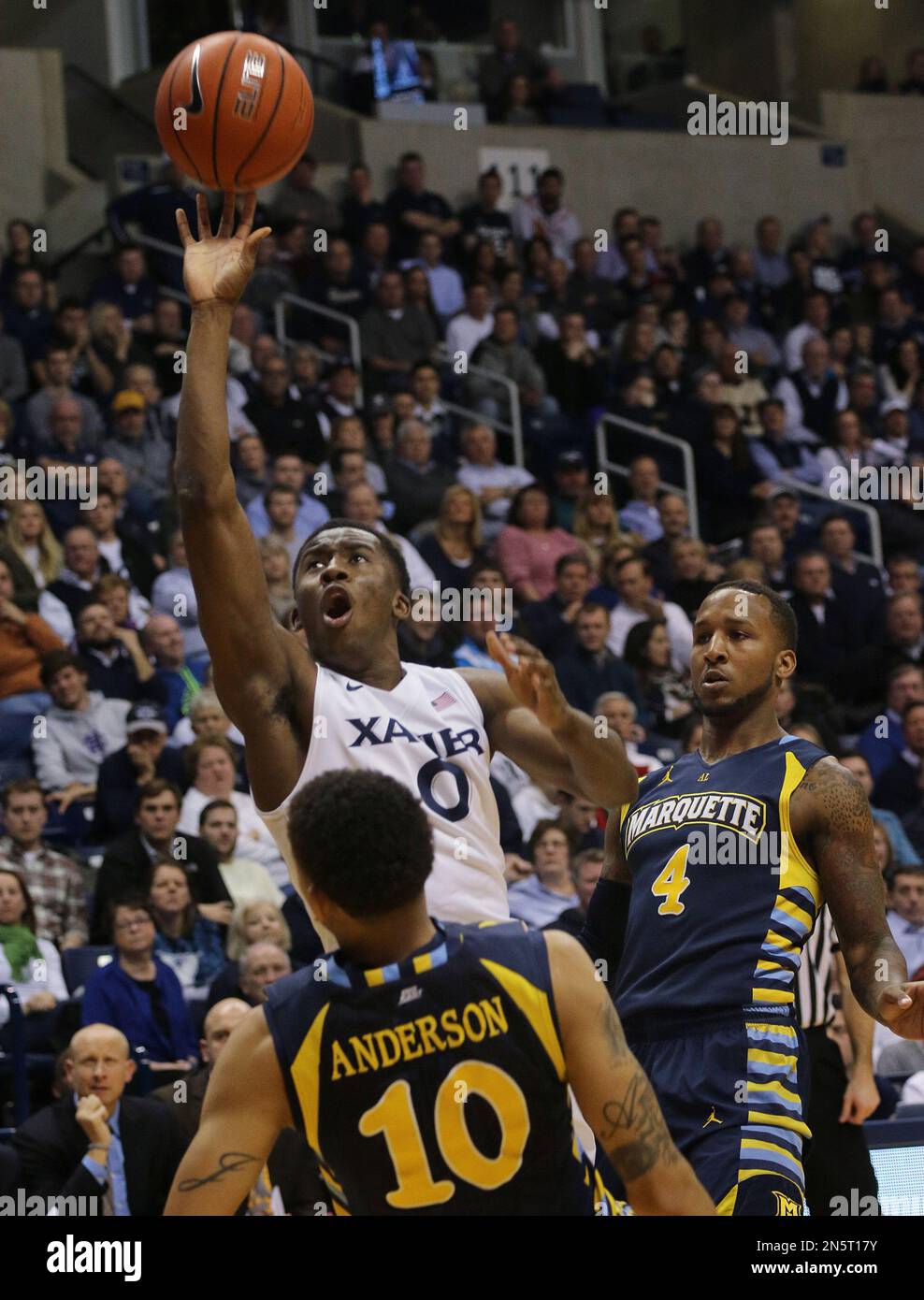 Xavier Semaj Chirston shoots past Marquette's Juan Anderson, 10, and ...