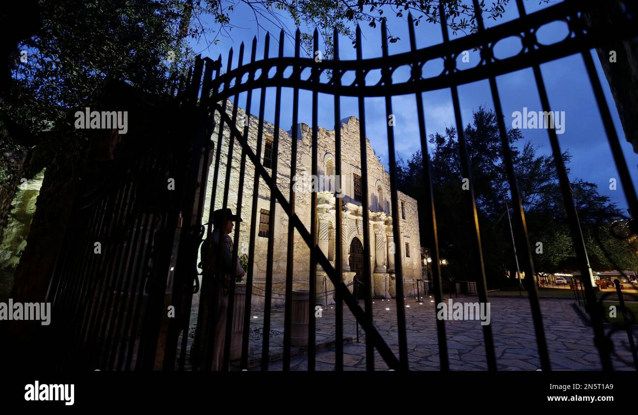 An Alamo police officer stands guard at the gates to the grounds of the ...