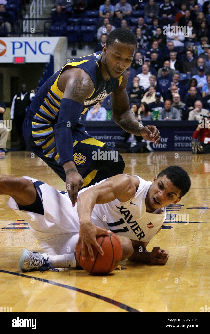 Xavier's Isaiah Dee Davis grabs a loose ball past Marquette's Todd Mayo ...