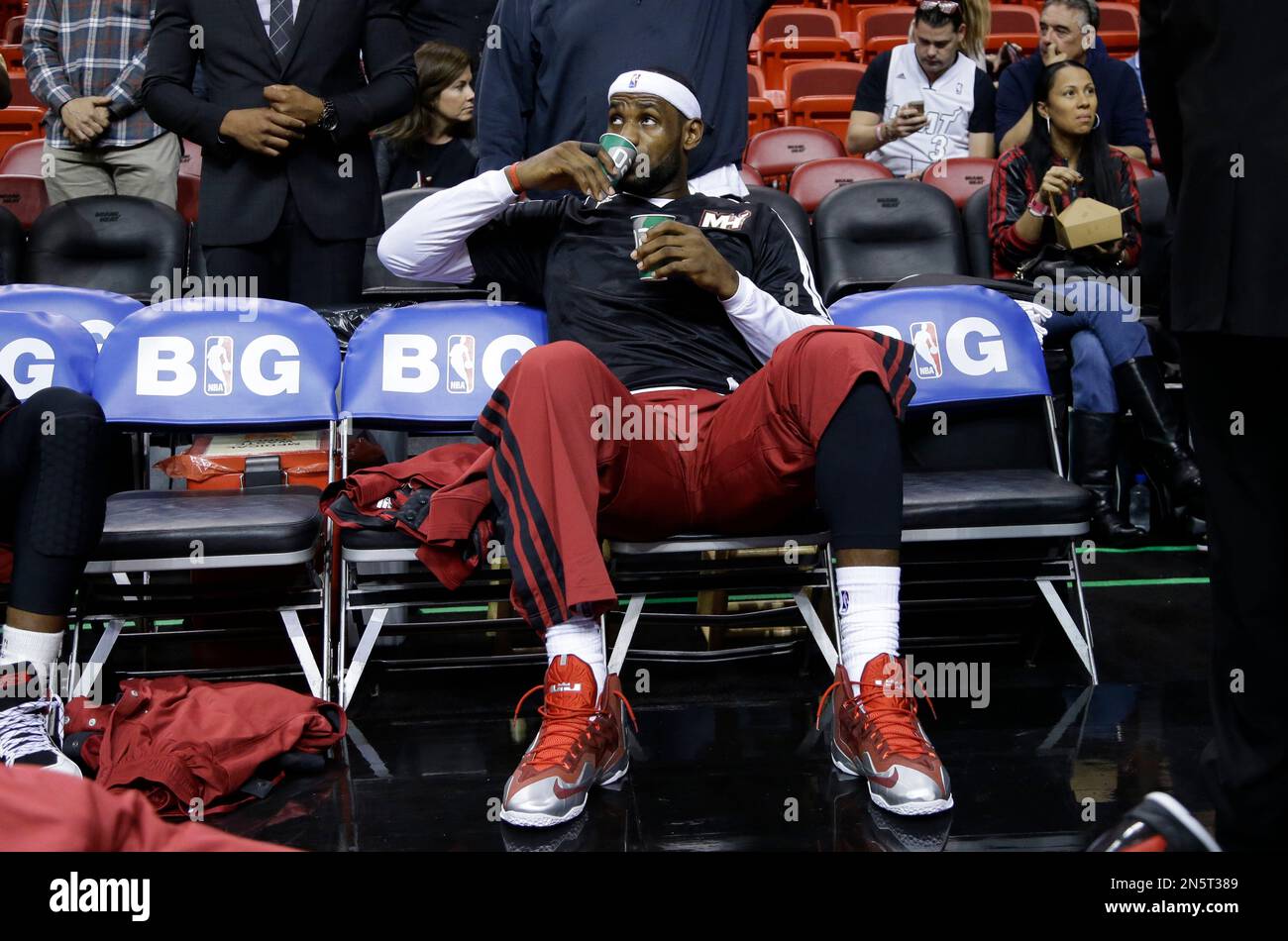 Miami Heat's LeBron James sits on the bench before an NBA basketball ...