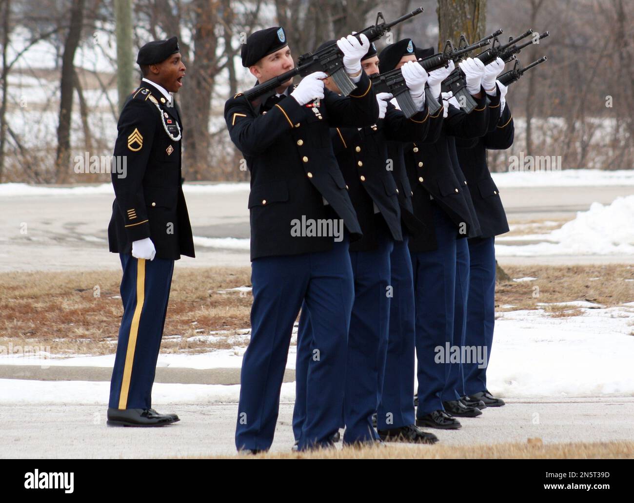 Staff Sgt. Michael Smith, left, gives the command to soldiers to fire a ...