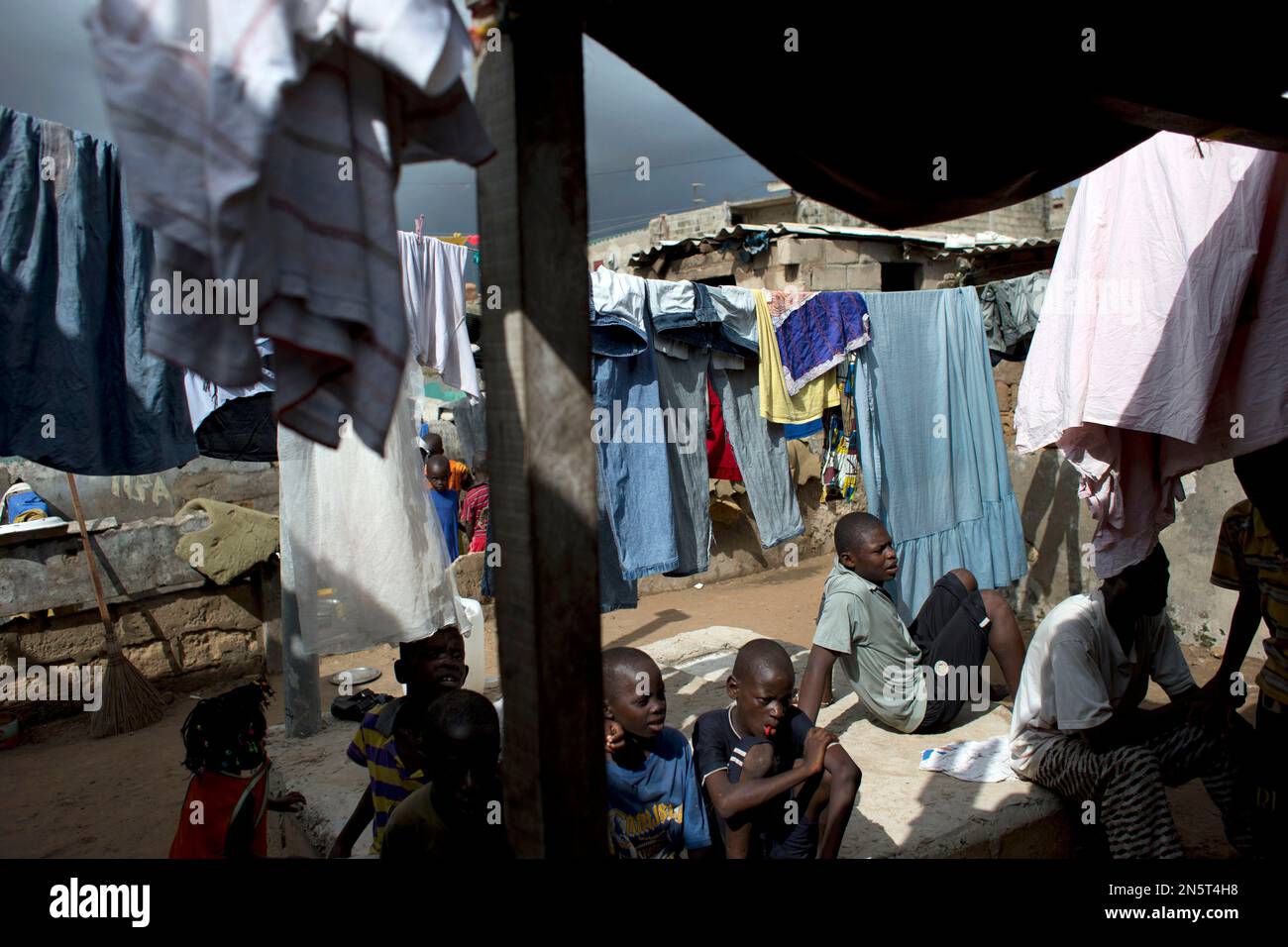 In this Aug. 15, 2013 photo, talibes lounge in the courtyard of their ...