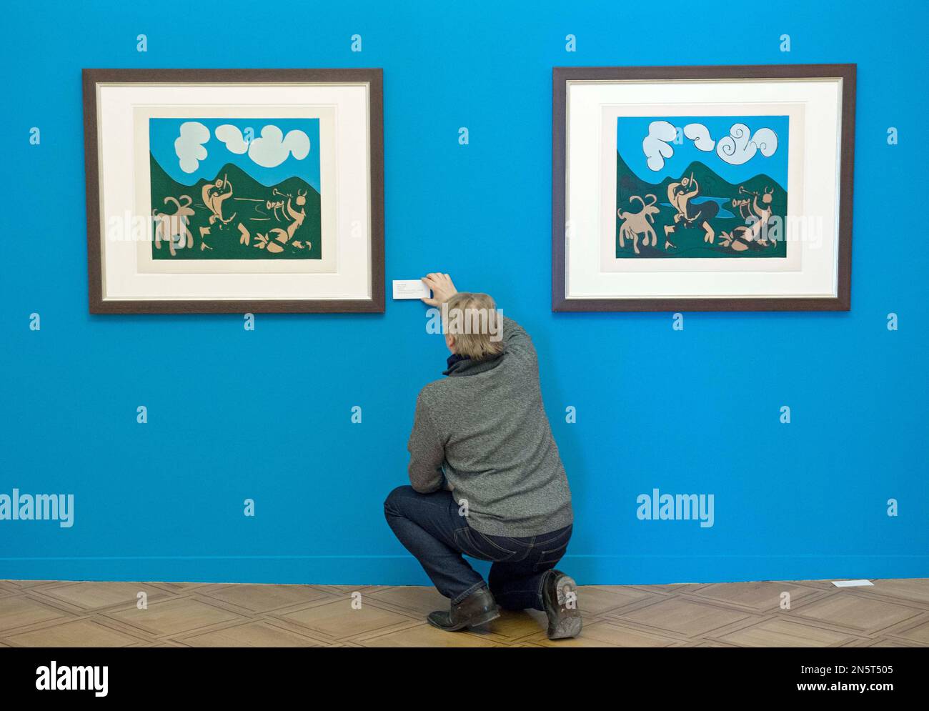 A man fixes a sign under the linocuts 'Faune und Ziege' (Fauns and ...
