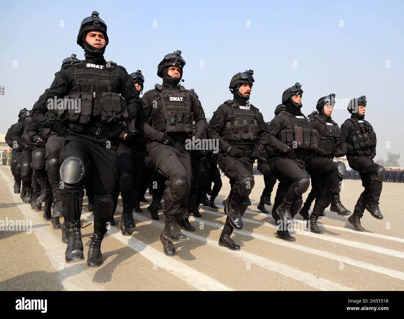 Members of Iraq's Special Weapons and Tactics Team (SWAT) march during ...