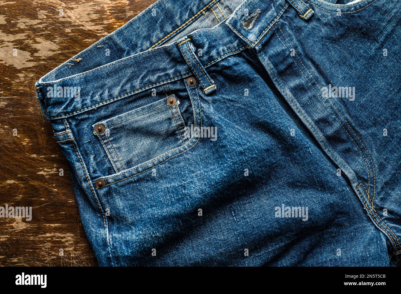 Worn and washed Japanese denim jeans with coin pocket, rivets and ...