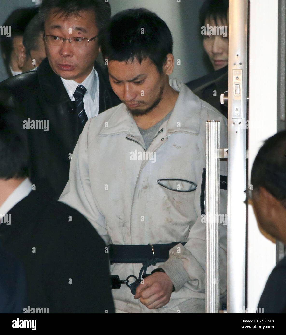 Rape suspect Yuta Sugimoto, center, is escorted from the Kawasaki ...