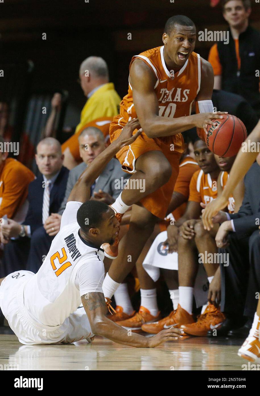 Texas forward Jonathan Holmes (10) jumps over Oklahoma State post ...