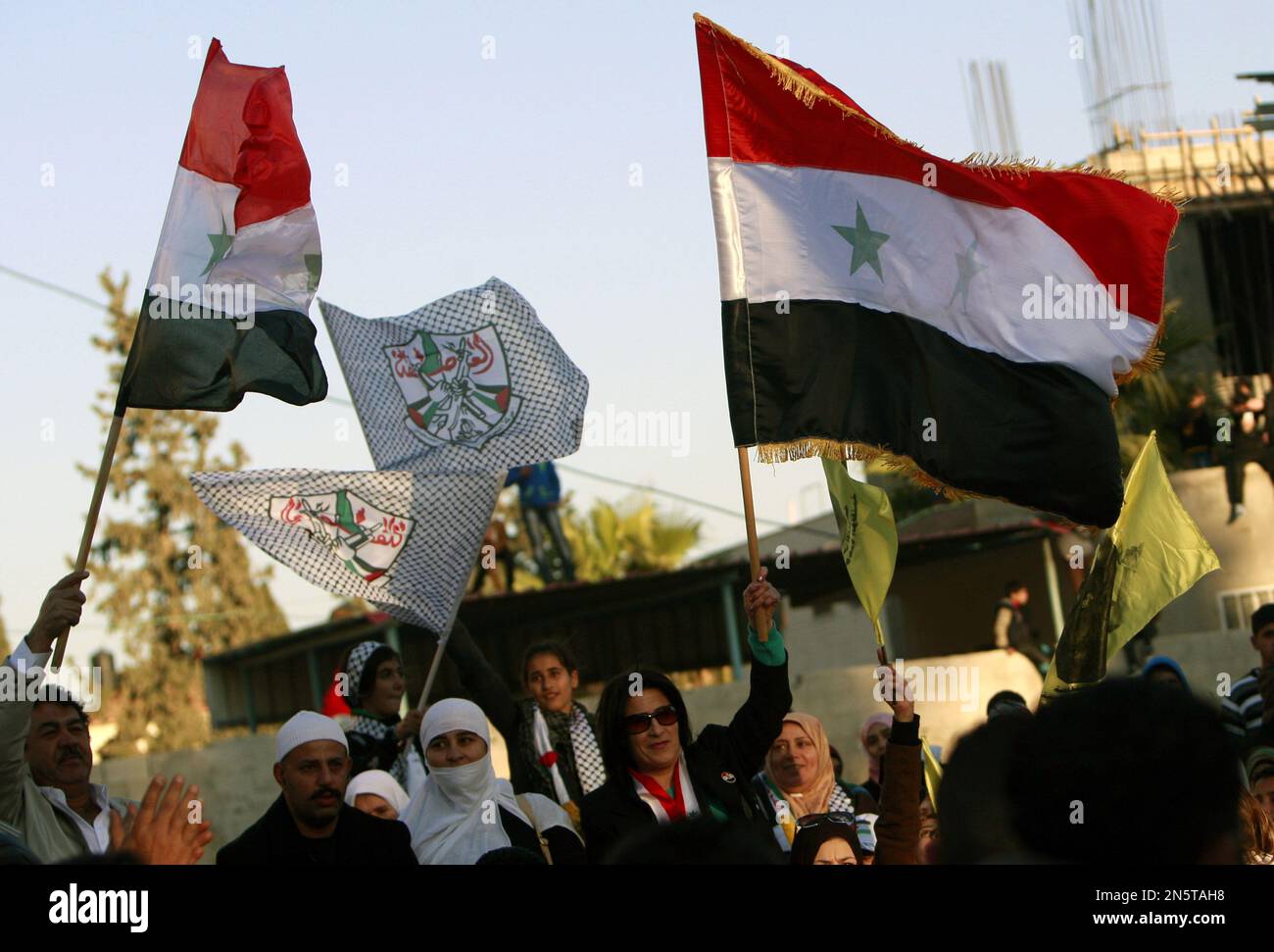 Palestinians wave Syrian and Fatah flags during a celebration for the ...