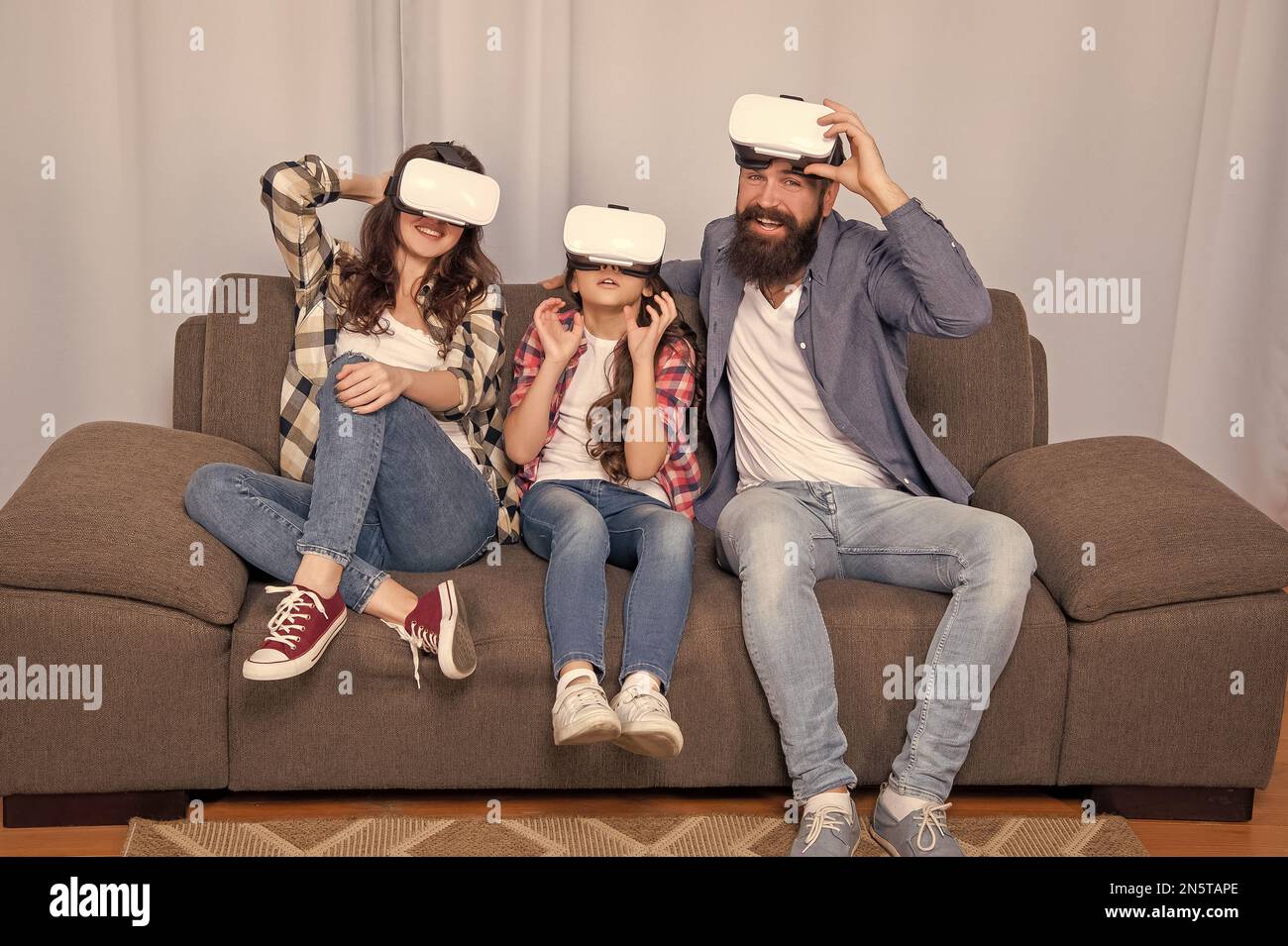 positive parents with kid spend time together in vr glasses at home ...