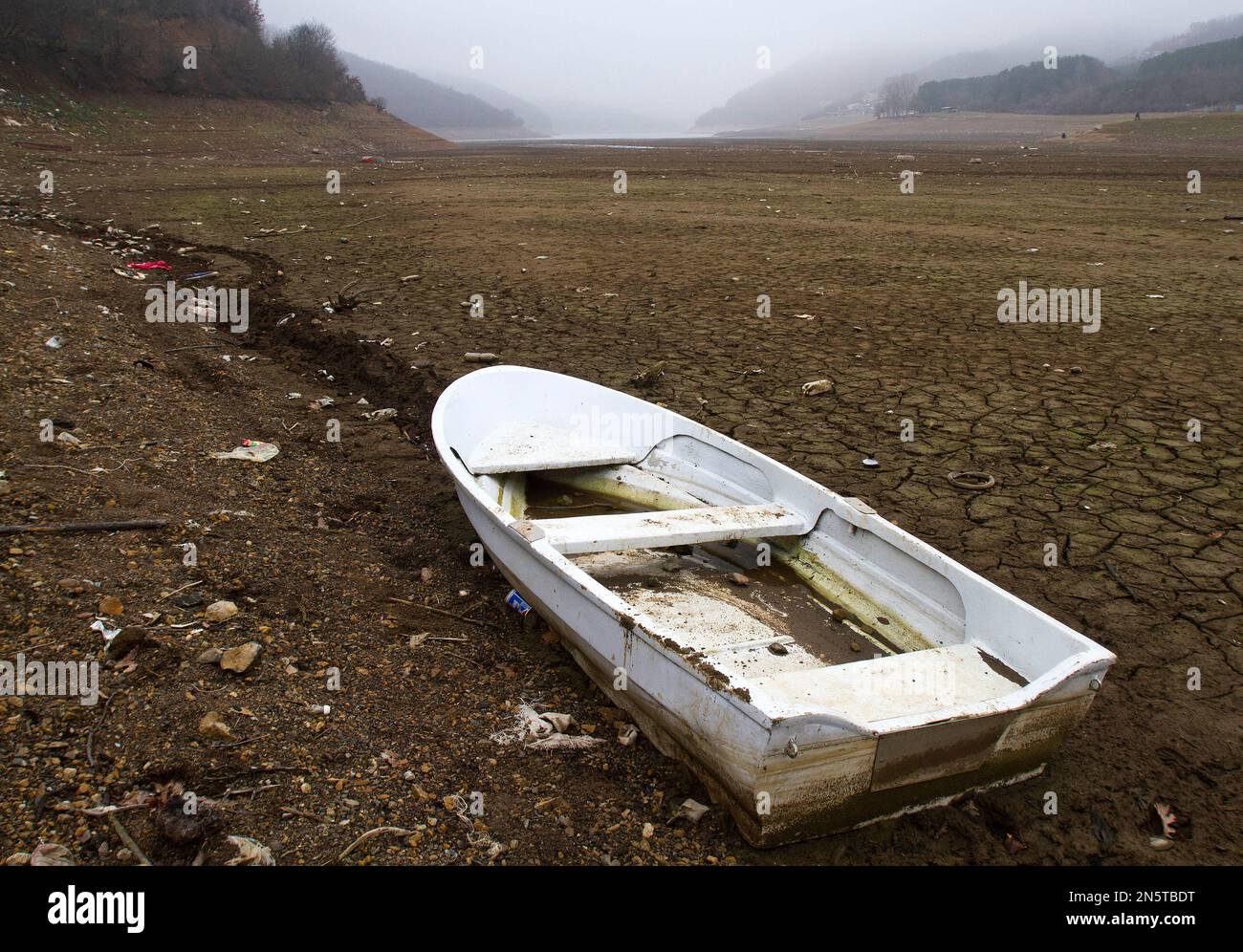 A boat lies stranded on the shores of the Batllava artificial lake in ...