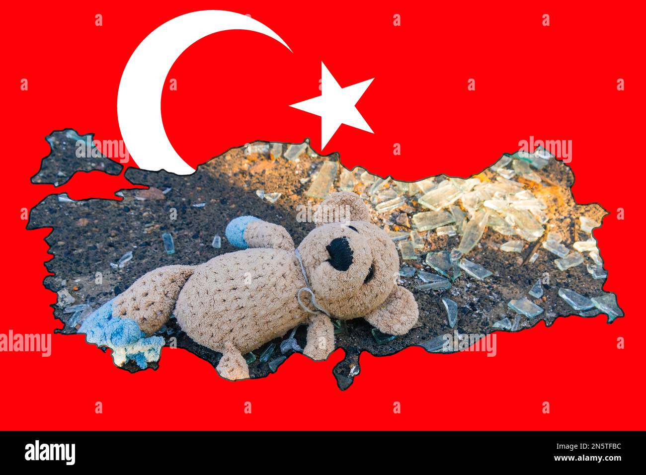Teddy bear lies on fragments of glass. Picture in the form of a map of ...