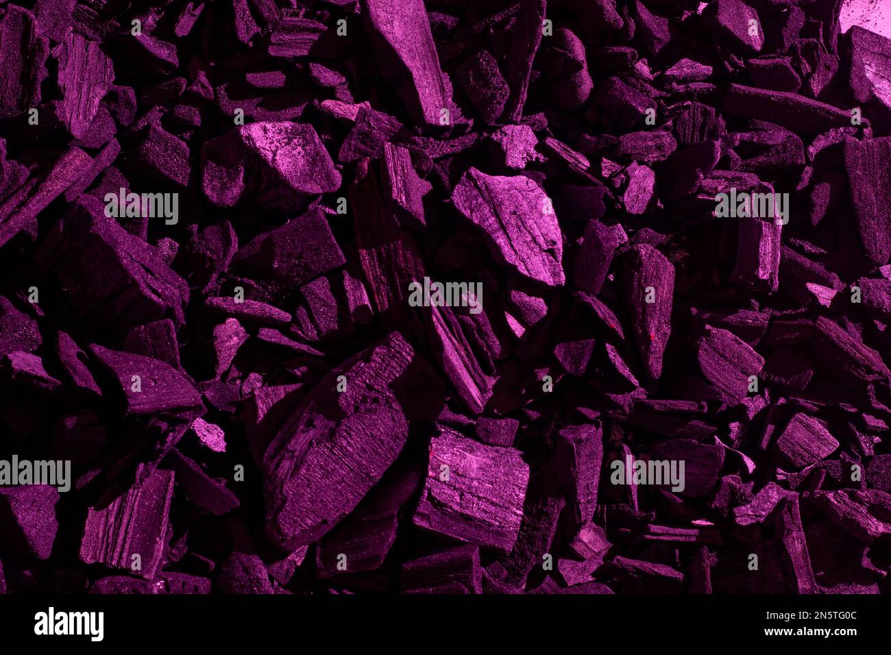 Natural black charcoal with a purple tint. Industrial coal. Pile of ...