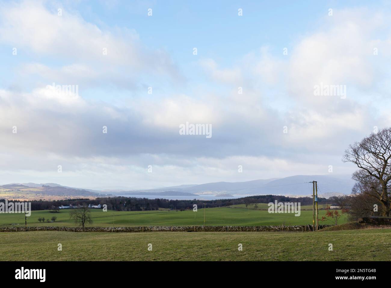 View with a blue sky and white clouds to Loch Lomond and the hills ...