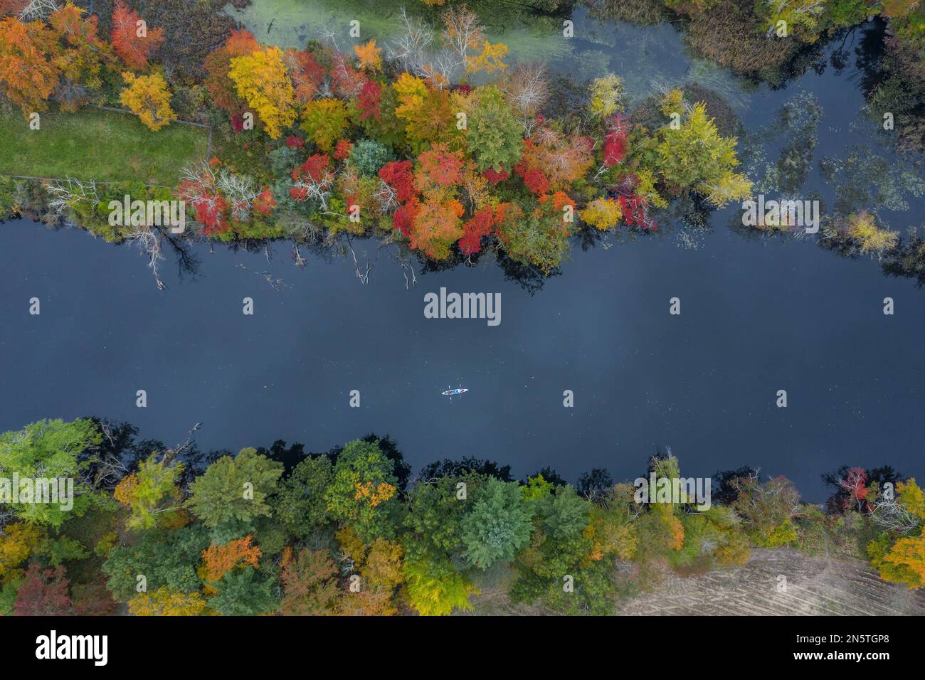 Aerial view of a kayak on river in autumn -Nashua River, Pepperell ...