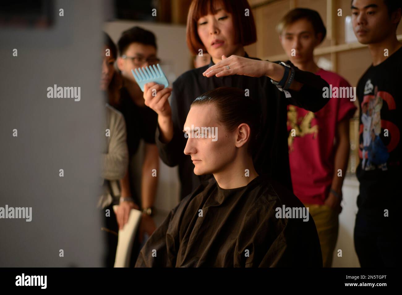 A model has hair and make up done at the Lee Roach collection backstage ...