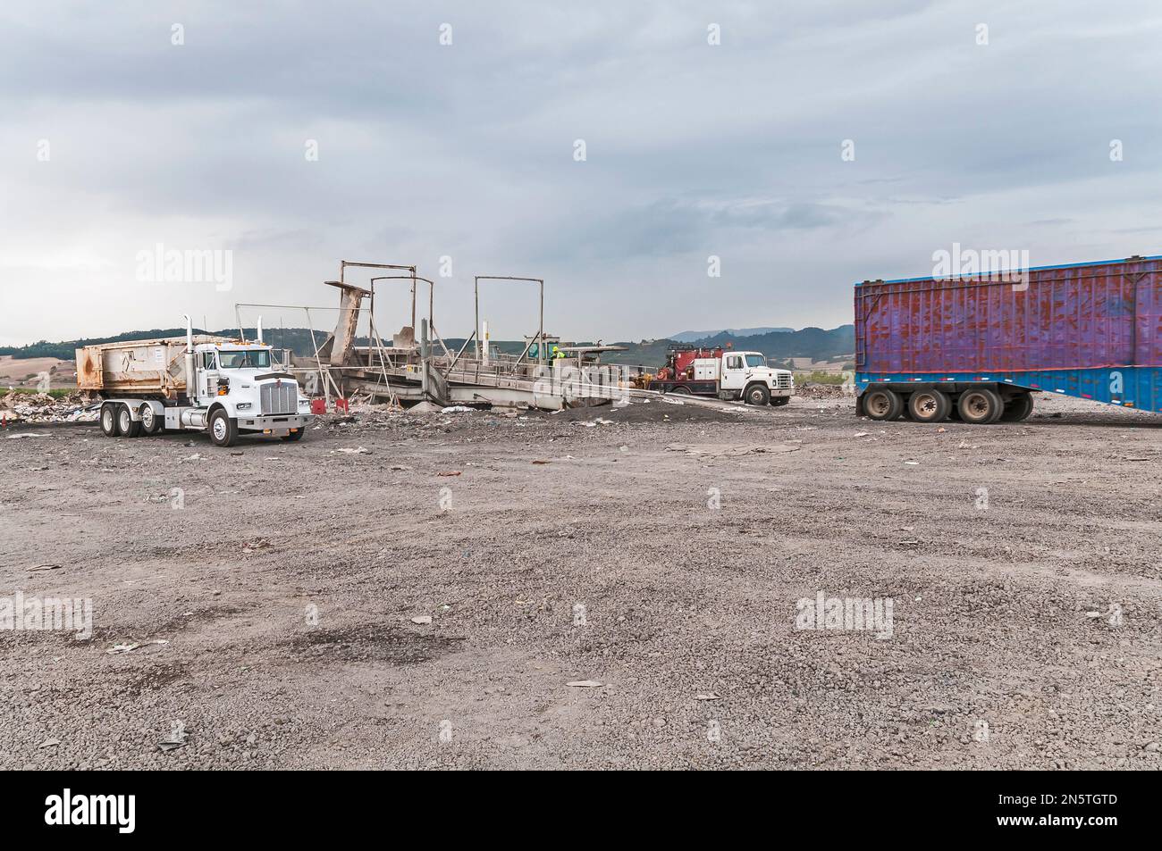 Semi-Trailer either backing up into or leaving tipper unit at an active ...