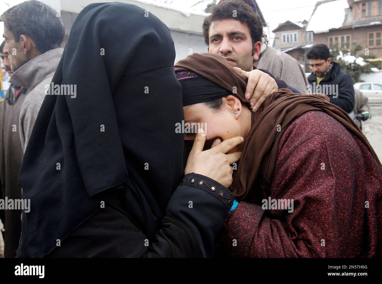 Family members of a slain Indian police officer cry as they arrived to ...