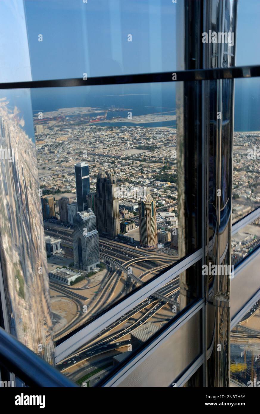 Reflections in a window high up on the Burj Khalifa, Dubai, United Arab ...