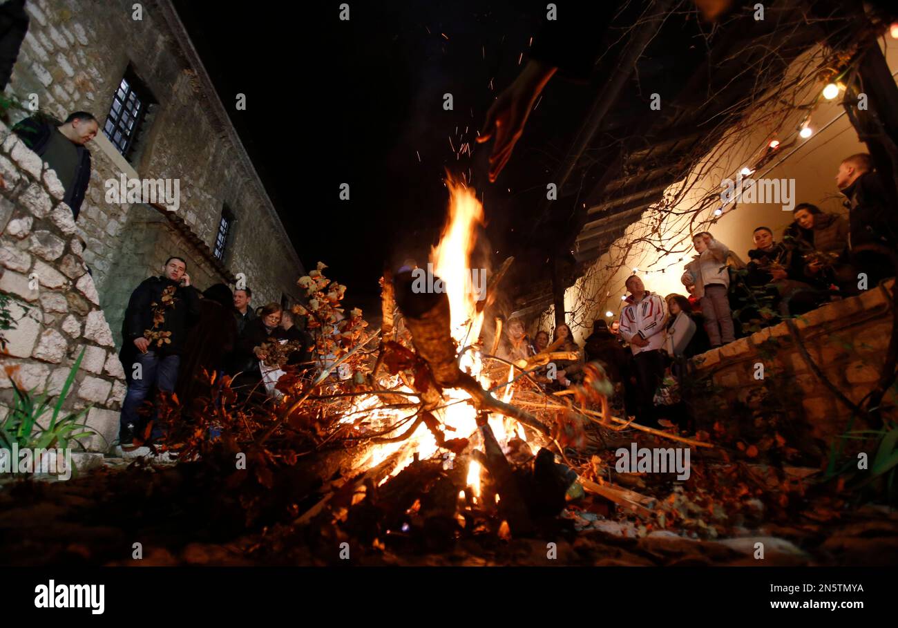 Bosnian Serb people gather around a fire of dried oak branches, the ...