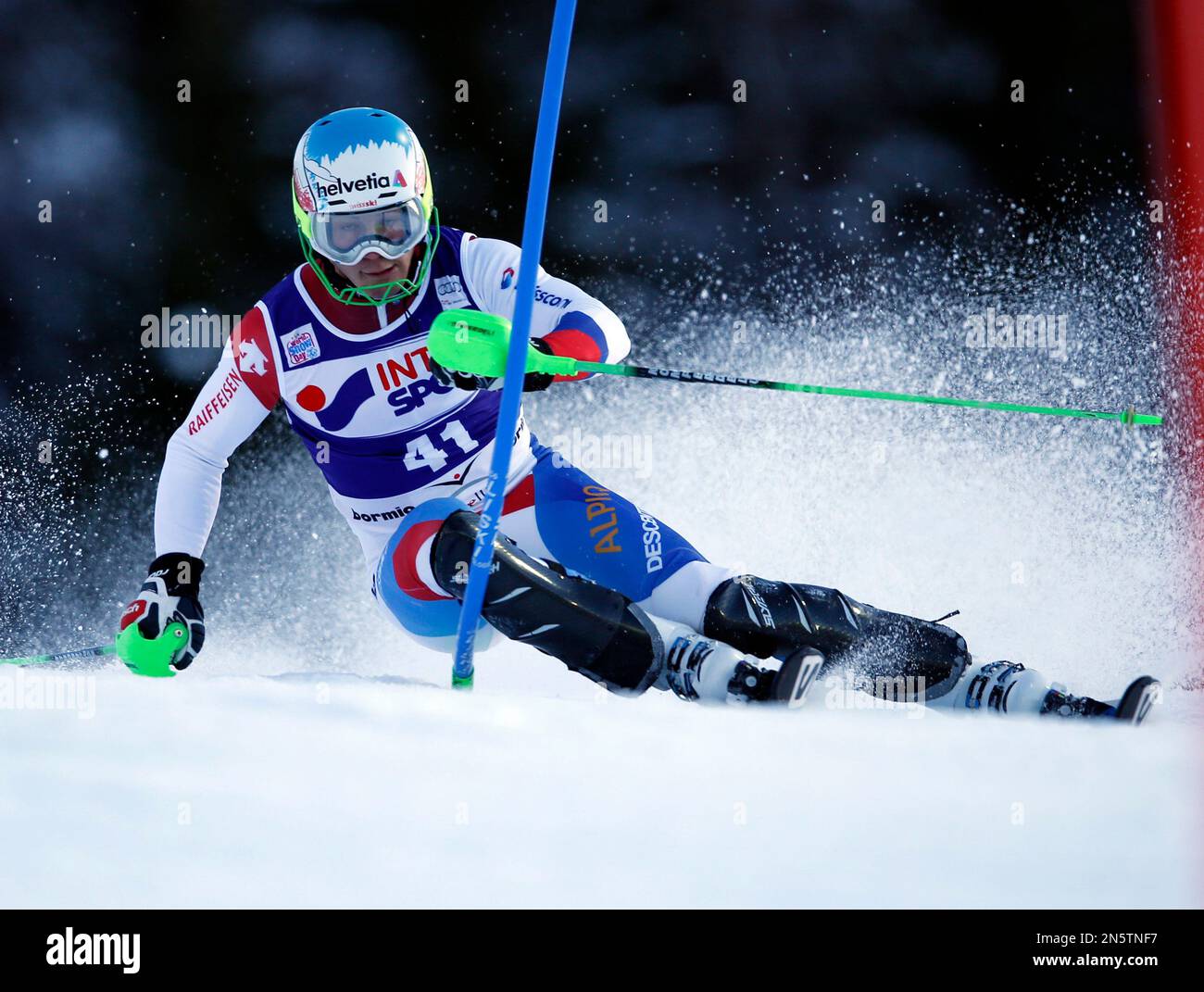 Switzerland's Luca Aerni speeds past a pole during the first run of an ...