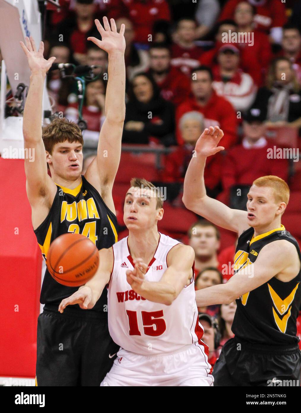 Wisconsin's Sam Dekker (15) passes against Iowa's Adam Woodbury (34 ...