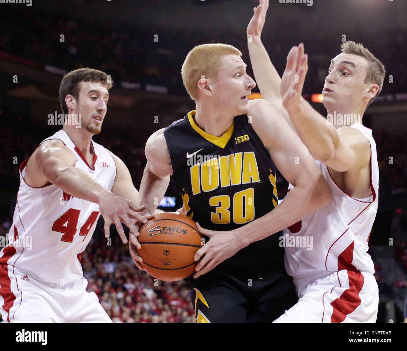 Wisconsin's Frank Kaminsky, left, and Sam Dekker trap Iowa's Aaron ...