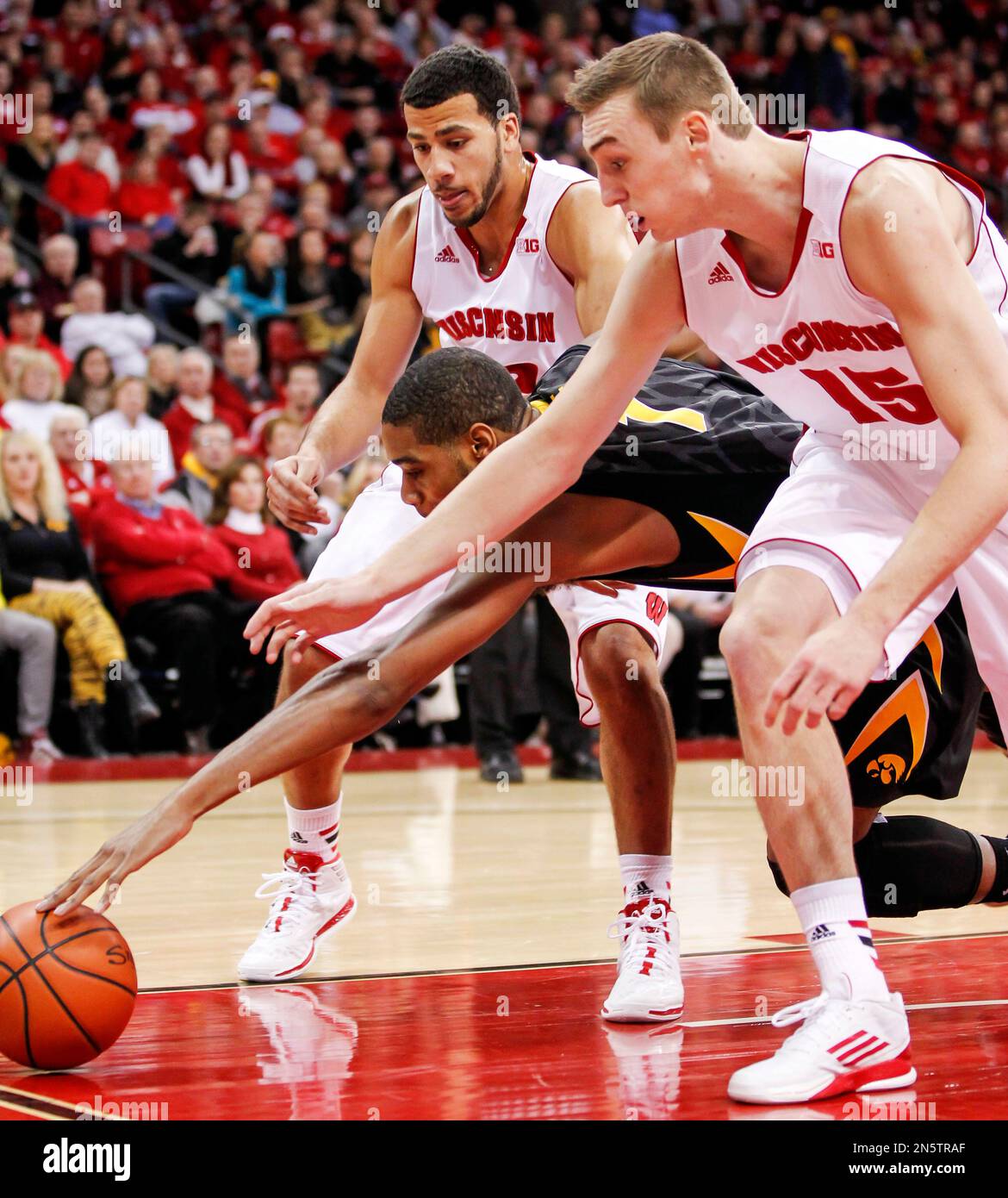 Iowa's Melsahn Basabe, center, battles with Wisconsin's Traevaon ...