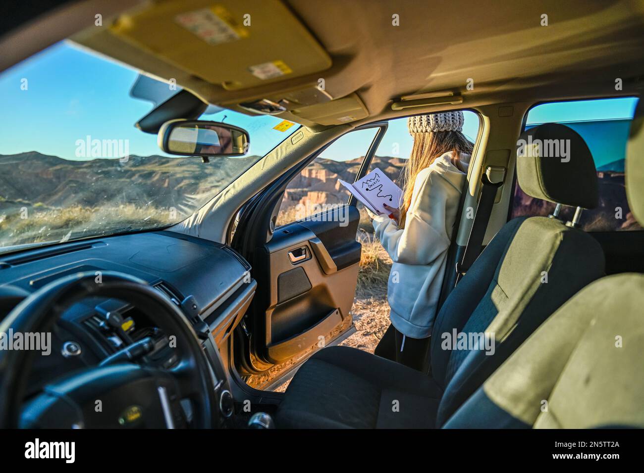 Girl looking at the map, of the route to follow, with the car Stock ...