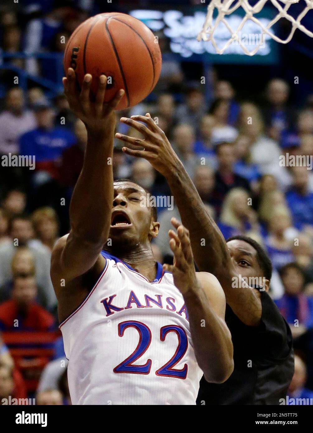 Kansas' Andrew Wiggins (22) puts up a shot under pressure from San ...