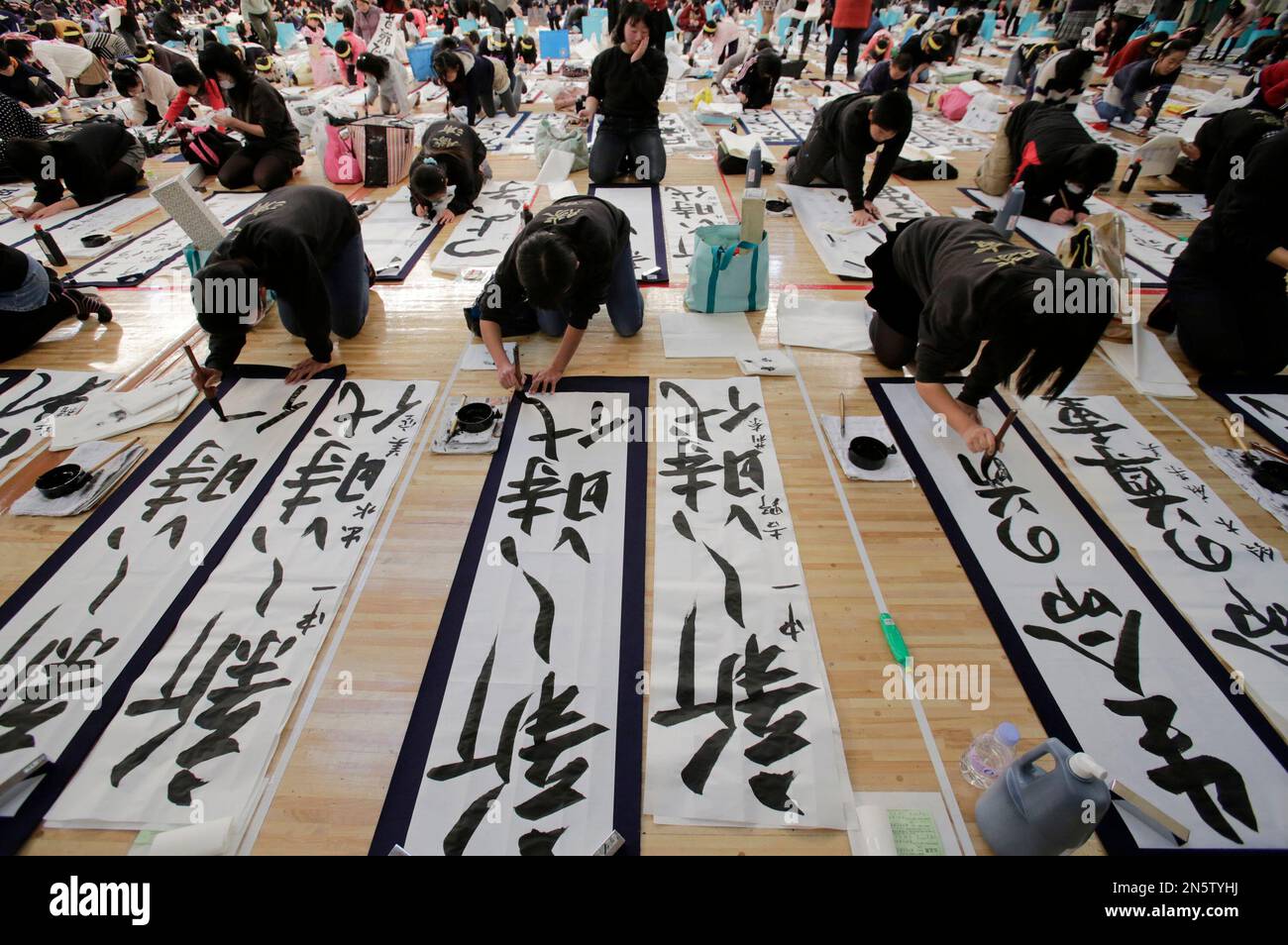 Participants write traditional Japanese calligraphy during the annual ...