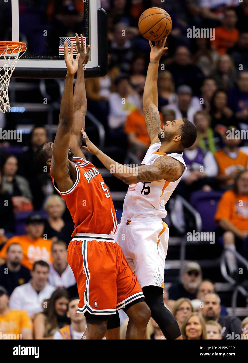Phoenix Suns' Marcus Morris, right, shoots over Milwaukee Bucks' Ekpe ...