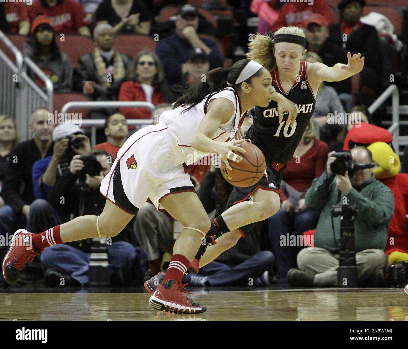 Louisville guard Bria Smith, left, drives against Cincinnati defender ...