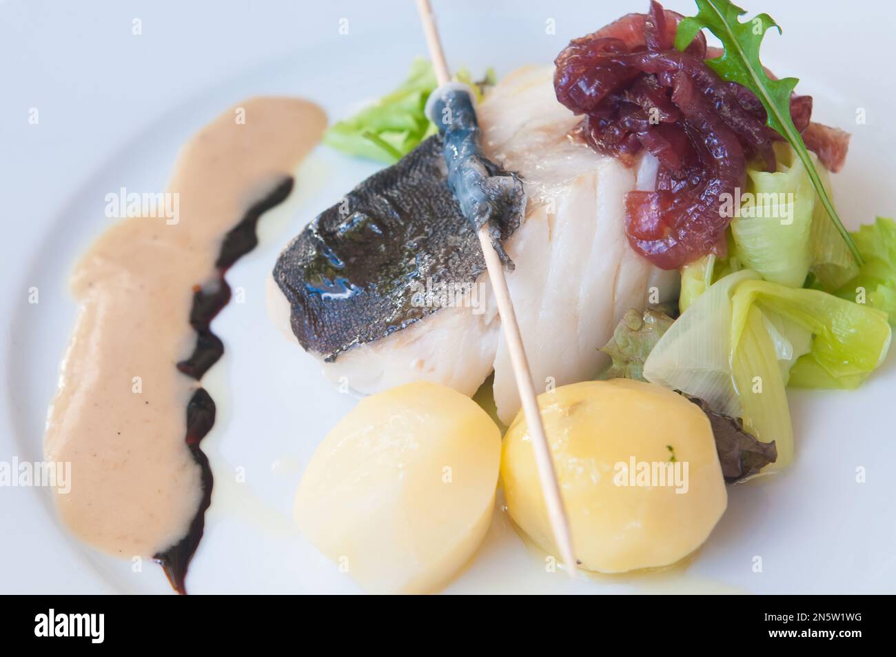 Delicious cod dish with its skin and garnish Stock Photo - Alamy