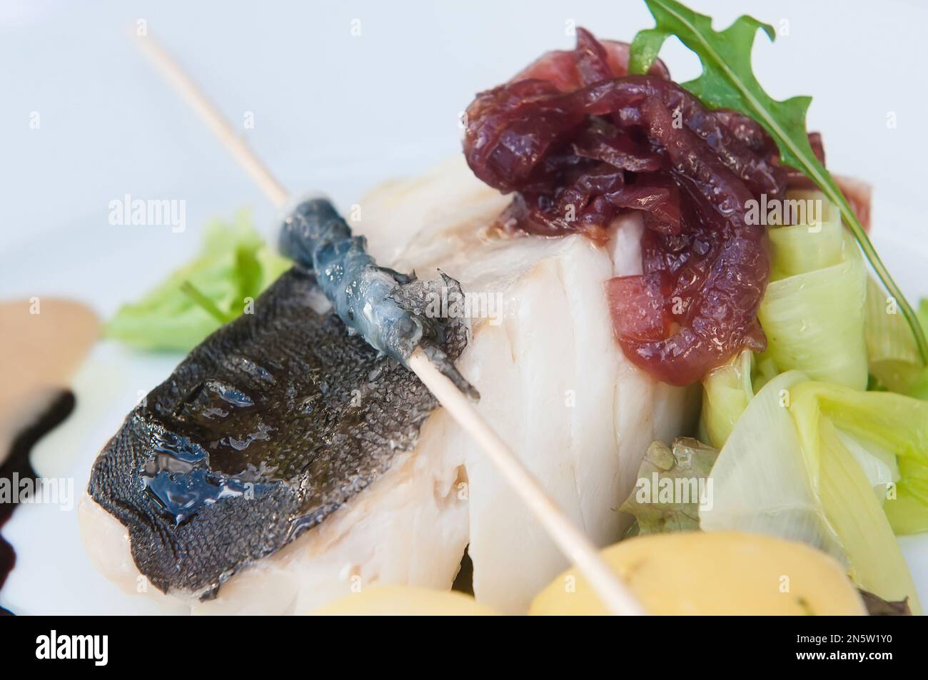 Delicious cod dish with its skin and garnish Stock Photo - Alamy