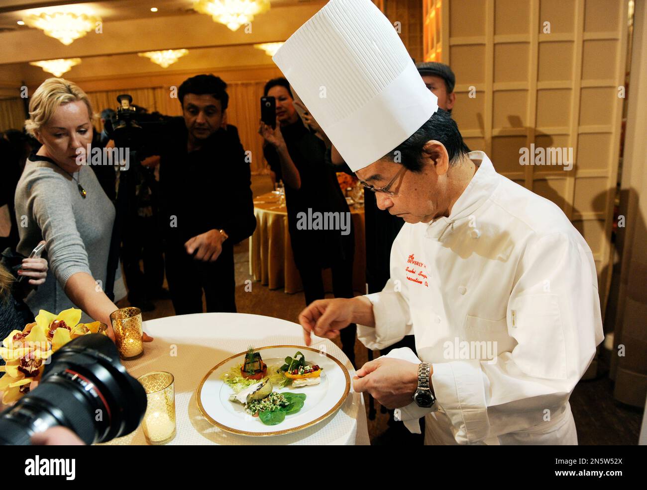 Executive Chef Suki Sugiura primps menu items as reporters gather ...