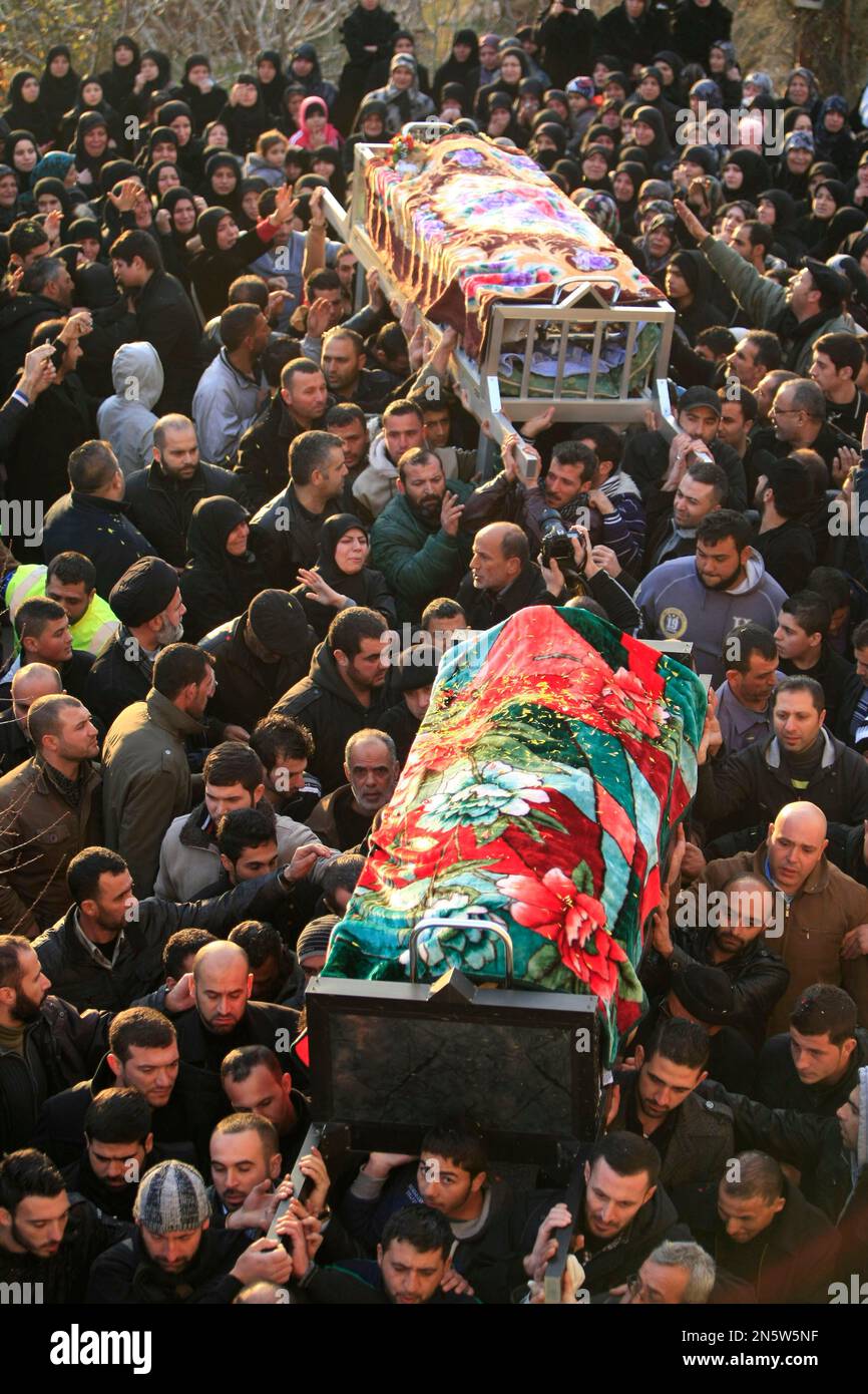 Lebanese mourners carry the coffin of Iman Zahweh and her daughter ...