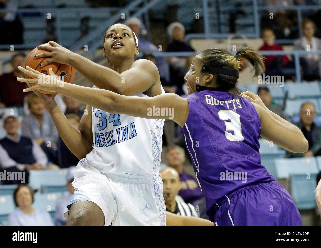 North Carolina's Xylina McDaniel (34) drives to the basket as James ...