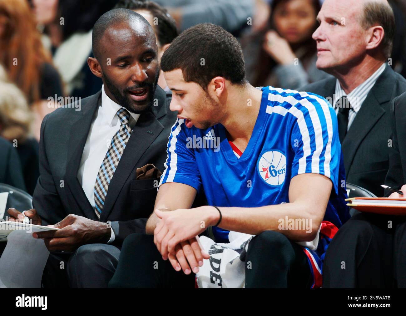 Philadelphia 76ers assistant coach Lloyd Pierce, left, talks with guard ...