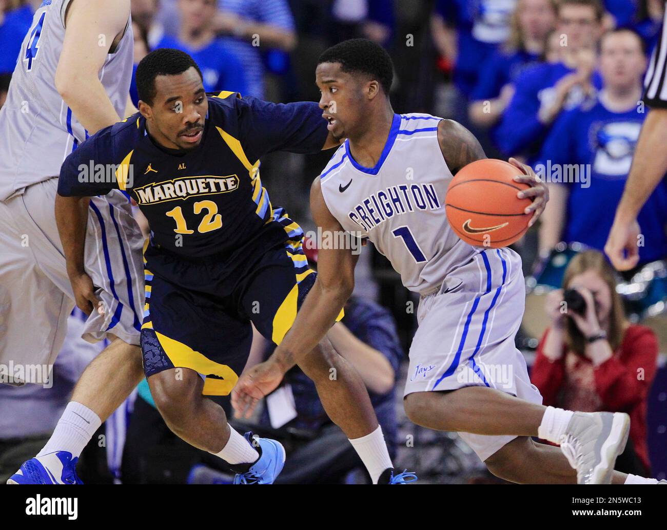 Creighton's Austin Chatman (1) drives around Marquette's Derrick Wilson ...