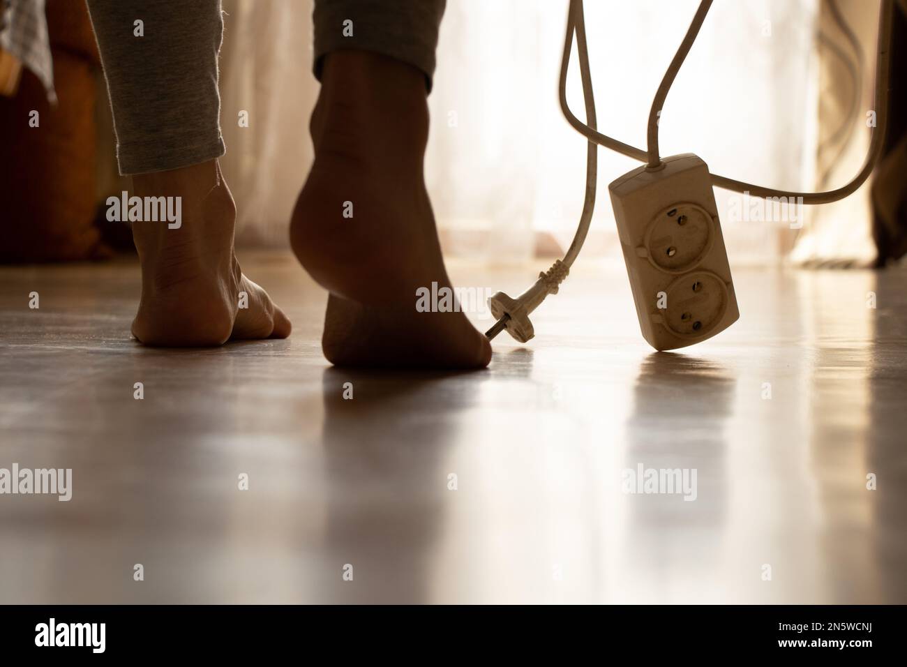 Women's legs and an extension leg stretcher in the hands of a girl in ...