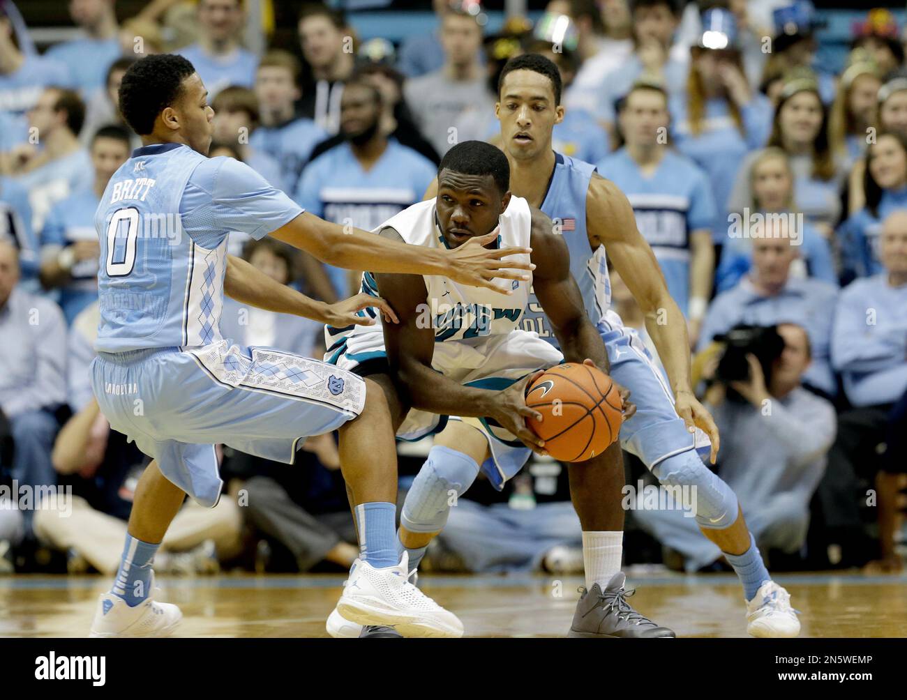 North Carolina's Nate Britt (0) and J.P. Tokoto guard UNC Wilmington's ...