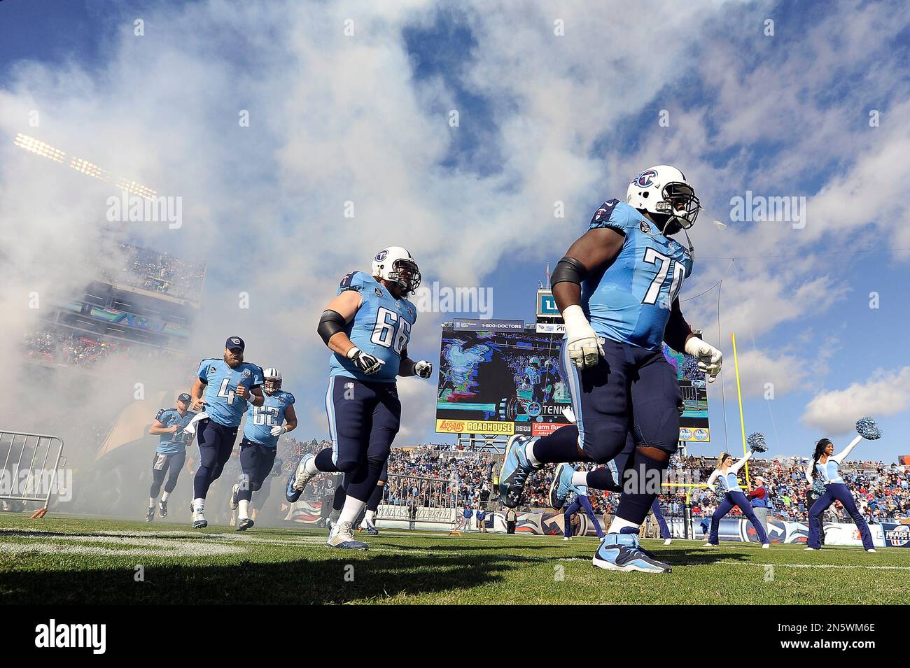 Tennessee Titans players Ryan Fitzpatrick (4), Michael Otto (66) and ...