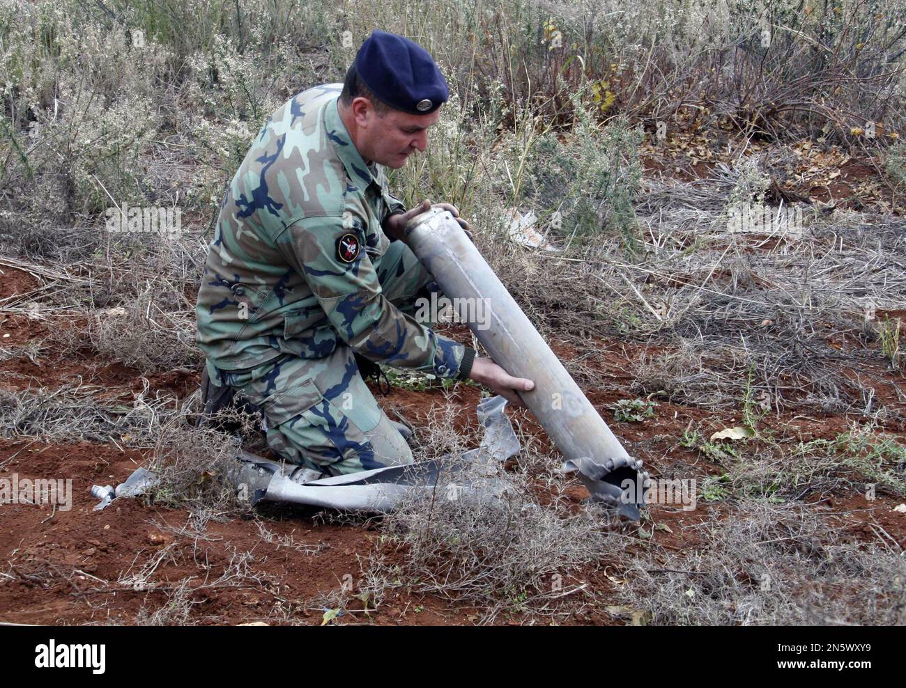 A Lebanese army soldier holds remains of a rocket that struck northern ...
